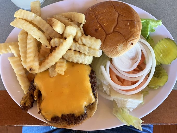 This isn't just a cheeseburger—it's a testament to simplicity done right, with crinkle-cut fries standing at attention alongside.