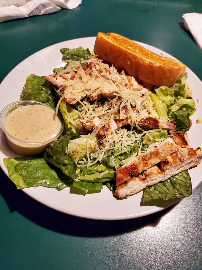 A Caesar salad that Julius himself would approve of—crisp romaine, perfectly grilled chicken, and a side of garlic bread for good measure.