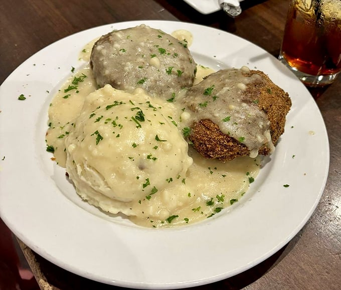 Golden-brown chicken croquettes bathed in velvety gravy alongside cloud-like mashed potatoes—comfort food that hugs you from the inside.