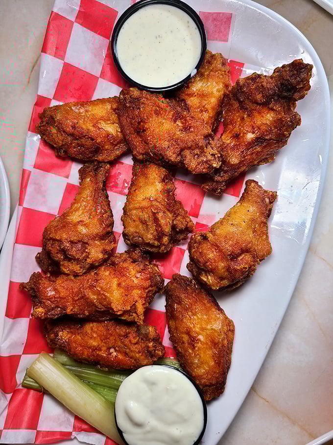 Wings that don't need a sporting event as an excuse—crispy, golden-brown perfection served with cooling dips and the mandatory celery sticks.