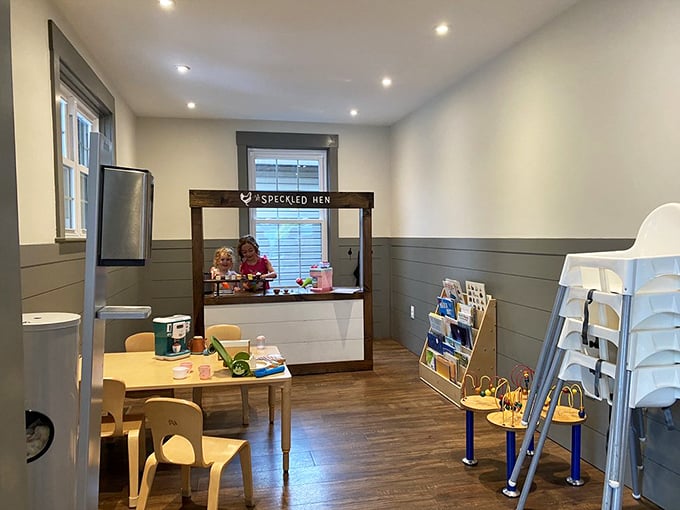 A children's play area that understands parents need coffee too. This thoughtful space keeps little ones entertained while grown-ups enjoy their momentary escape into caffeine bliss.