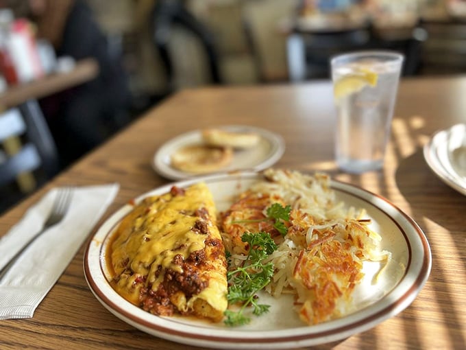 This omelet doesn't just satisfy hunger—it negotiates peace treaties with it, while the hash browns stand by as delicious, crispy witnesses.