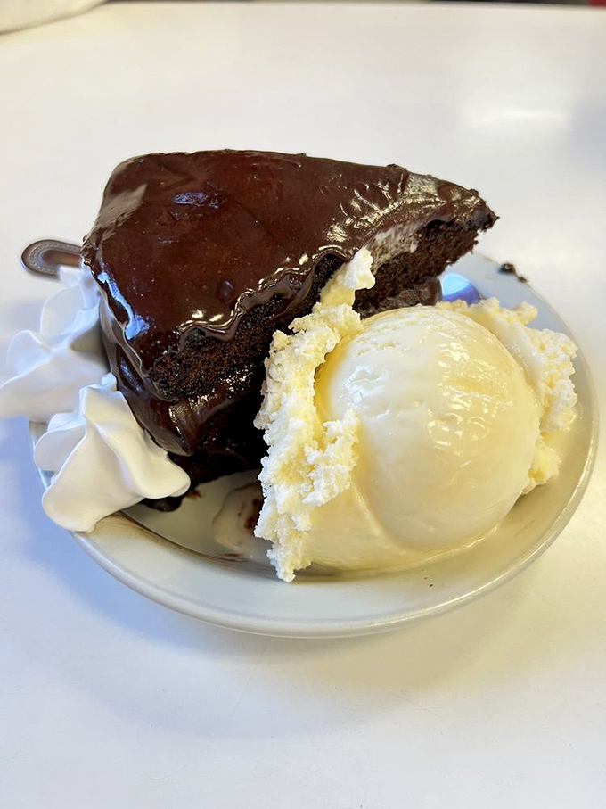 This chocolate cake doesn't just satisfy cravings—it creates them. The vanilla ice cream isn't a side dish; it's a necessary companion on this journey.