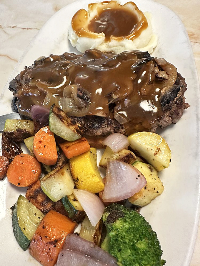Chopped steak smothered in mushroom gravy—comfort food that speaks a universal language. Those roasted vegetables aren't just healthy—they're absolution for the gravy.