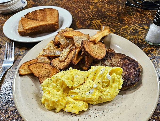Breakfast that doesn't apologize for its simplicity. Golden home fries, fluffy eggs, and a burger patty that doesn't care what time it is.