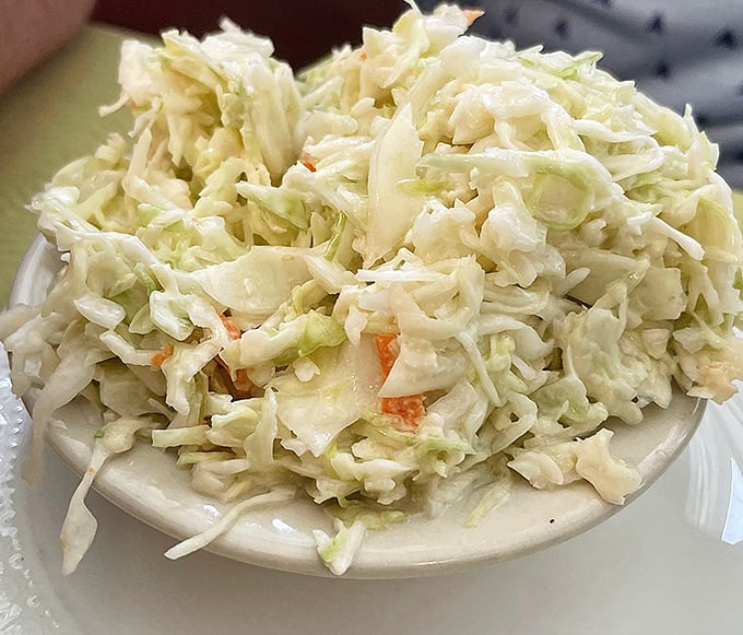 Coleslaw that knows its role—crisp, fresh counterpoint to rich barbecue. Not too sweet, not too tangy, just the perfect supporting actor to the meaty star.
