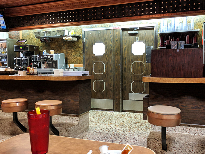 The swinging kitchen doors – a portal where ordinary ingredients enter and comfort food magic emerges.