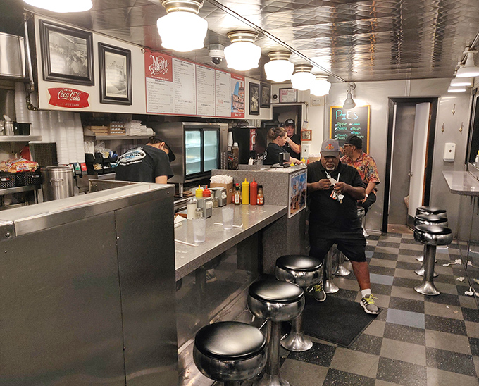 The narrow diner layout creates an intimate experience where everyone's part of the same culinary adventure, separated only by a few chrome stools.