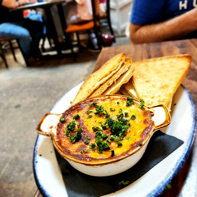 This bubbling crab dip, topped with fresh herbs and served with golden triangles of toast, is what appetizer dreams are made of.
