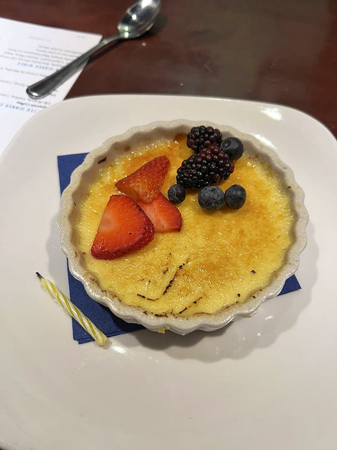 This crème brûlée isn't just dessert—it's a study in contrasts. That crackling caramelized top gives way to silky custard below, with berries for a touch of tartness.