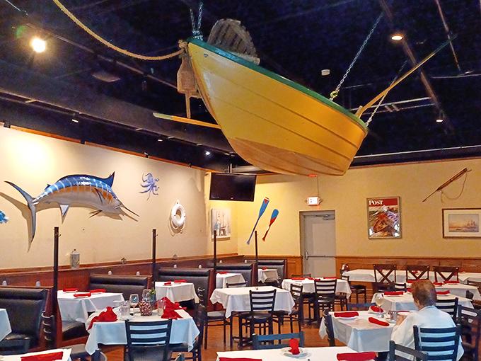 A yellow boat suspended from the ceiling—because nothing says "serious seafood restaurant" like dining beneath a vessel that never touches water.