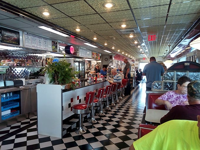 The counter ballet: where regulars perch on red vinyl thrones and waitresses perform the choreography of coffee refills and order-taking. 