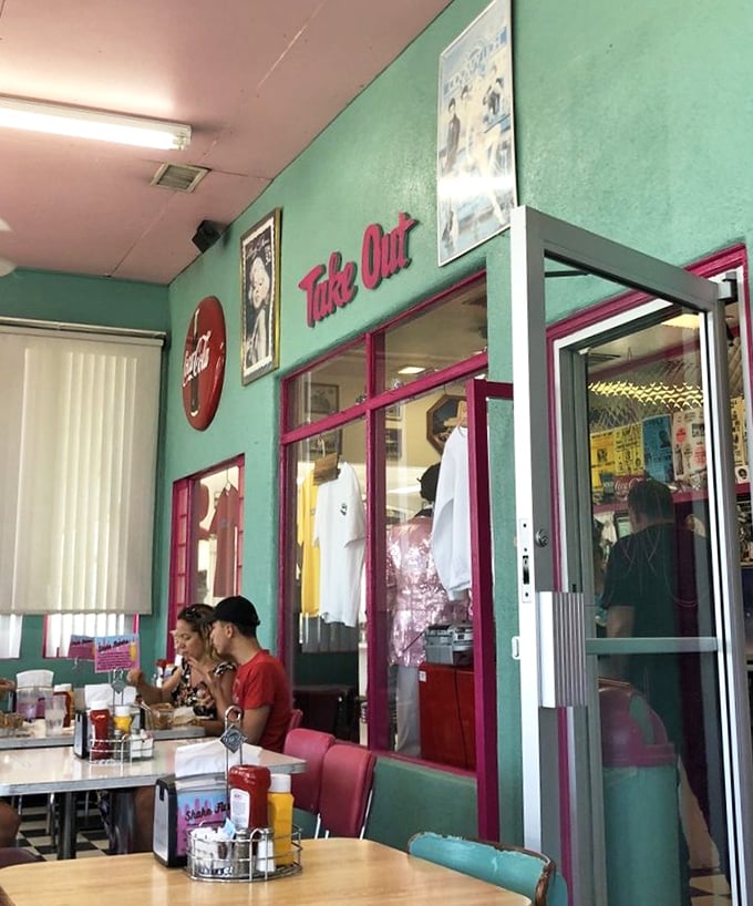 The "Take Out" sign promises you can take the flavors home, but you'll miss half the experience—the people-watching and nostalgic atmosphere.