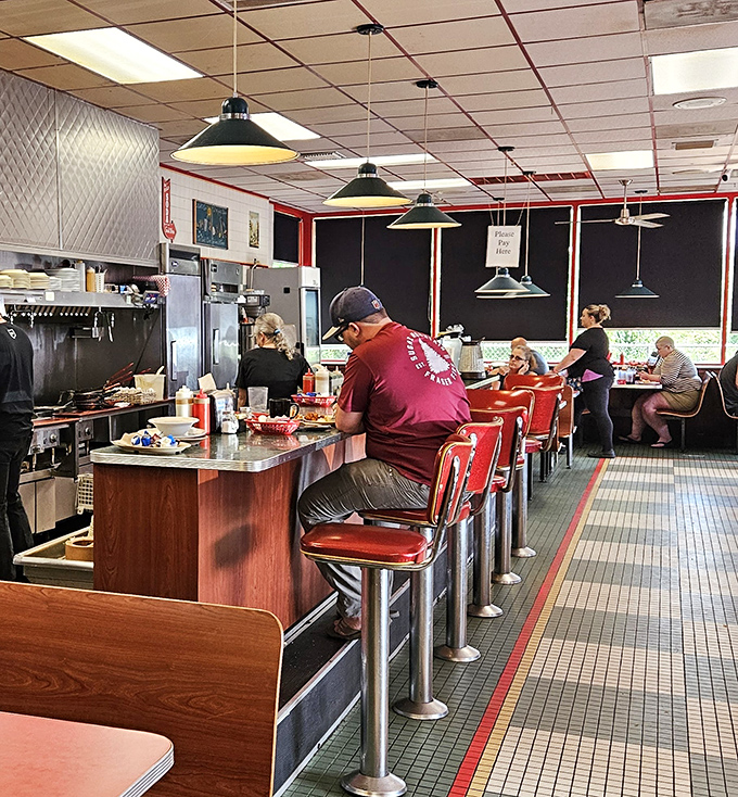 Morning rhythms at the counter—where solo diners find company and the staff moves with the choreographed precision of a breakfast ballet.