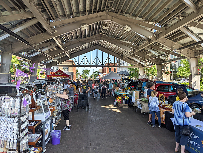 The farmers market buzzes with activity under protective covering – where local produce and handcrafted goods create a shopping experience that big box stores can't match.
