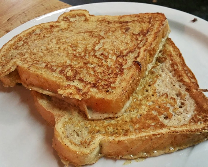 French toast that makes you wonder why anyone bothers with fancy brunch. Crisp edges, custardy center—breakfast nirvana.