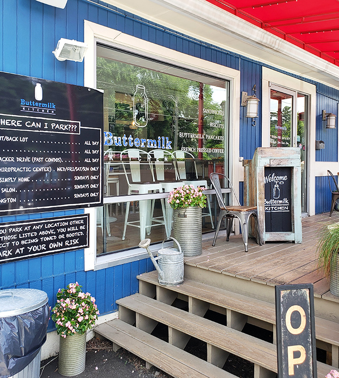 The entrance says it all: blue clapboard, metal chairs, and helpful parking instructions—because nothing should stand between you and great breakfast.