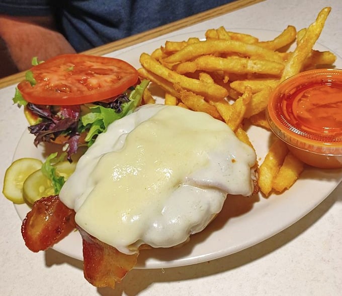 A sandwich that requires both hands and a stack of napkins – the universal sign of something worth every delicious, messy bite.