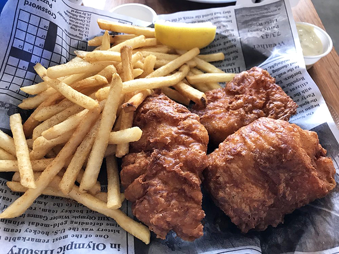 Fish and chips done right – crispy golden batter protecting flaky white fish, with fries standing by for the inevitable "just one more bite" syndrome.