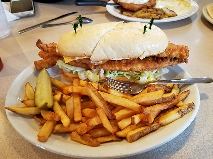 This sandwich isn't just lunch—it's an engineering marvel of crispy fish, fresh lettuce, and golden fries that makes you wonder why we don't eat like this for every meal.