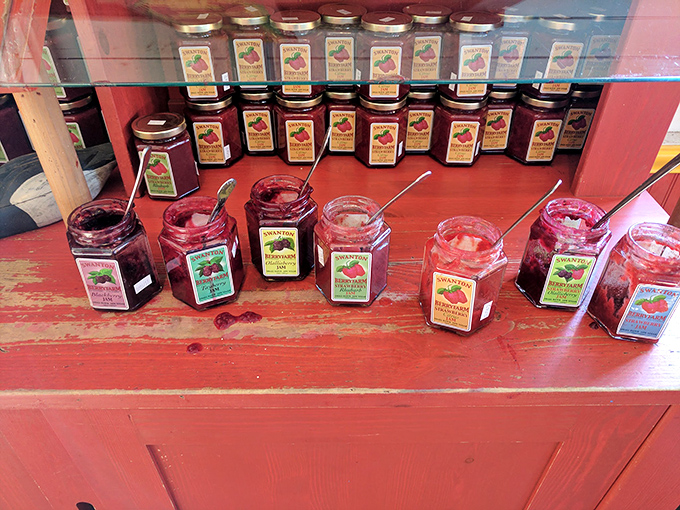An altar to preserved fruit—jars of jewel-toned jams with sampling spoons standing by. Resistance is futile.