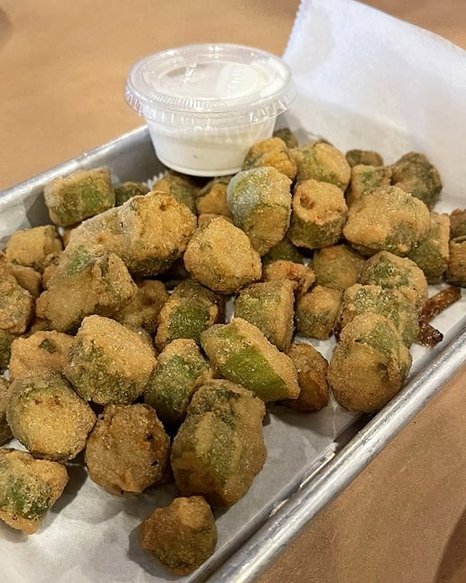 Fried okra that solves the eternal southern vegetable dilemma—crispy, golden exterior giving way to tender green goodness inside. Dipping sauce non-negotiable.