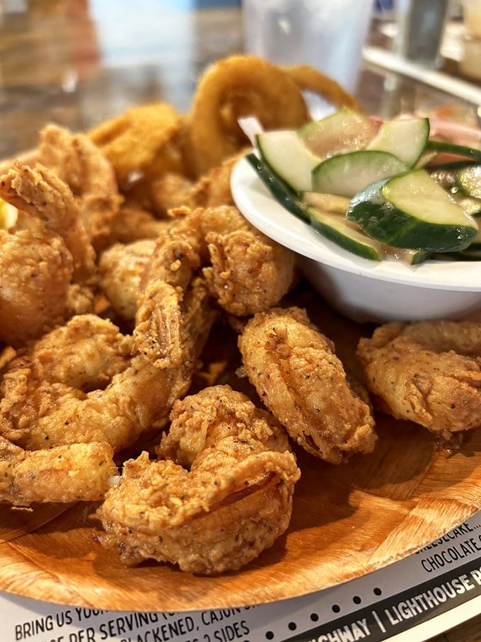 These golden-fried shrimp aren't just food—they're little nuggets of ocean sweetness wrapped in a crunchy hug. The cucumber salad provides moral support.
