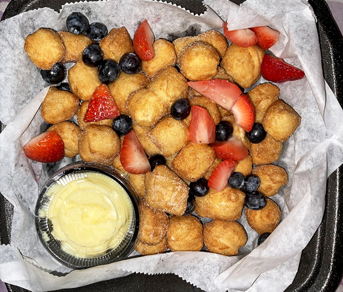 Fried dough bites with fresh berries – dessert that perfectly balances "I'm being somewhat healthy" with "but I definitely deserve this." 