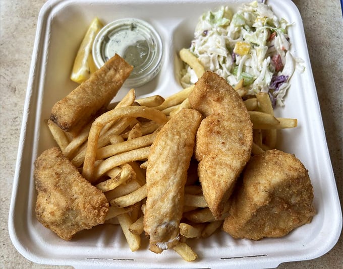 Golden-fried swordfish that makes you wonder why you ever bothered with chicken—served with fries and slaw for the complete coastal experience.