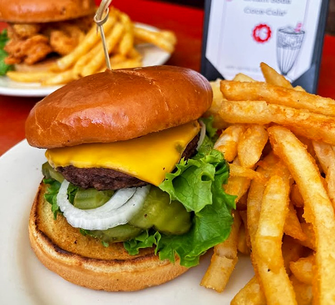 This isn't just a burger—it's an engineering marvel of beef, cheese, and fresh veggies that requires both hands and absolutely zero regrets.