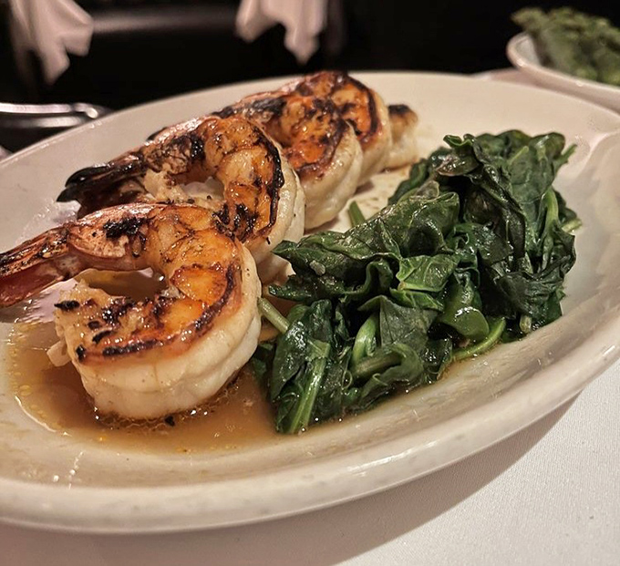 Shrimp so perfectly grilled they look like they jumped straight from ocean to flame to plate. That spinach isn't just a side—it's a worthy companion.