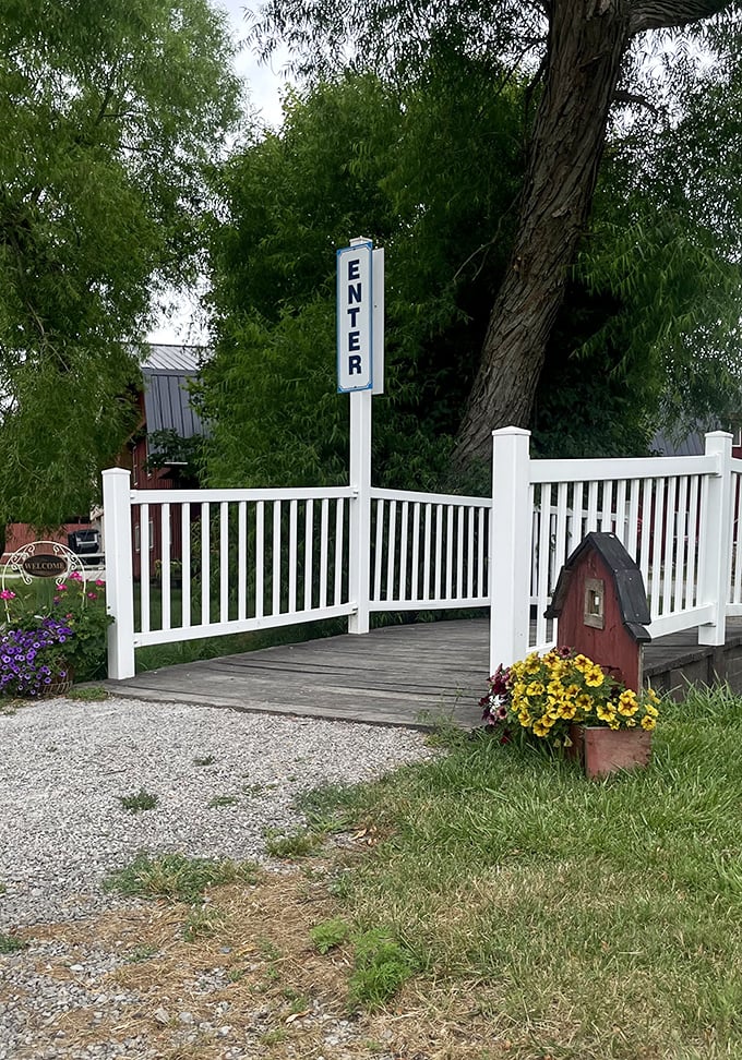 The entrance bridge welcomes visitors with cheerful flowers and a charming birdhouse—the Amish version of a five-star hotel lobby.