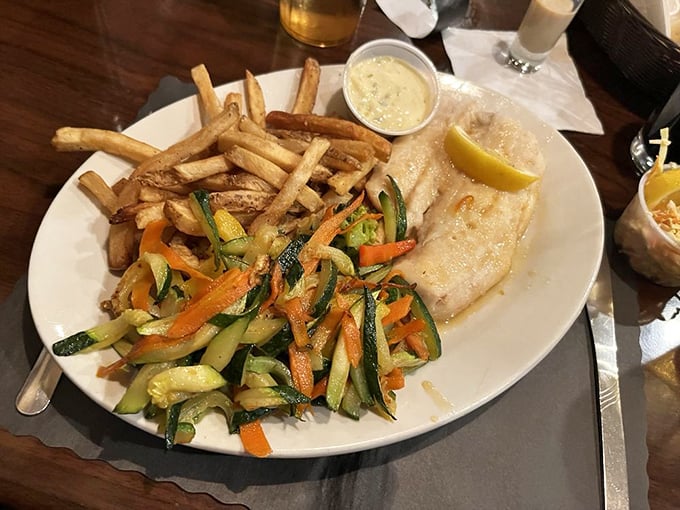 Fresh haddock, golden fries, and vibrant vegetables create the holy trinity of a proper fish dinner—comfort food that swims upstream against mediocrity.