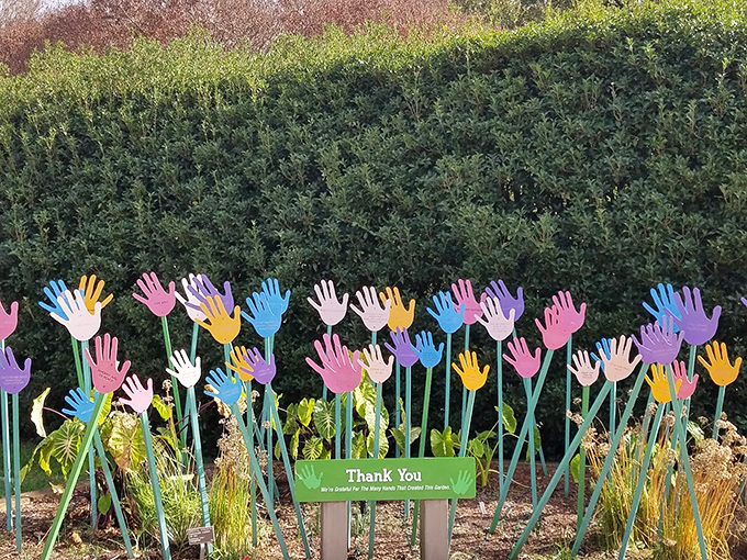 A garden that wears its heart on its sleeve—or rather, its hands in the air—celebrating the community that helps it thrive.