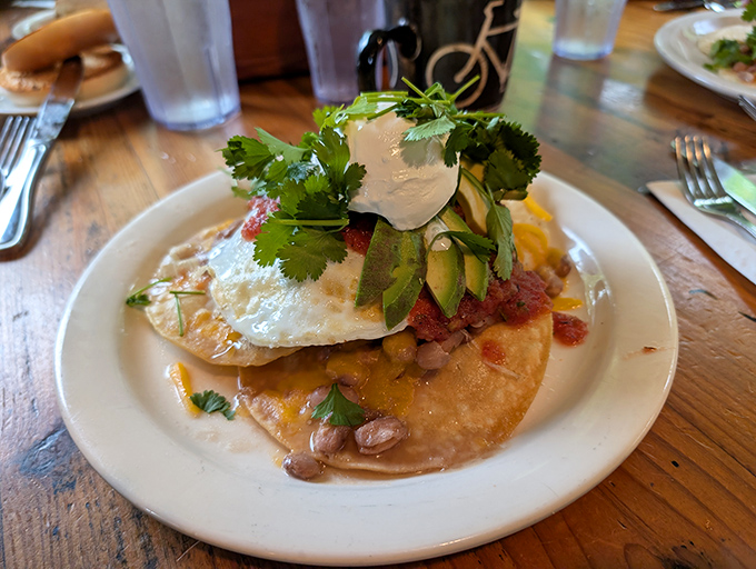 Huevos rancheros elevated to art form—a fiesta on a plate where the sunny-side egg is the undisputed star of the show.