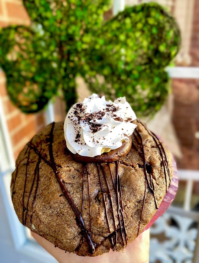 This cookie doesn't just have chocolate drizzle—it's wearing its finest outfit, complete with whipped cream hat and chocolate accessories.