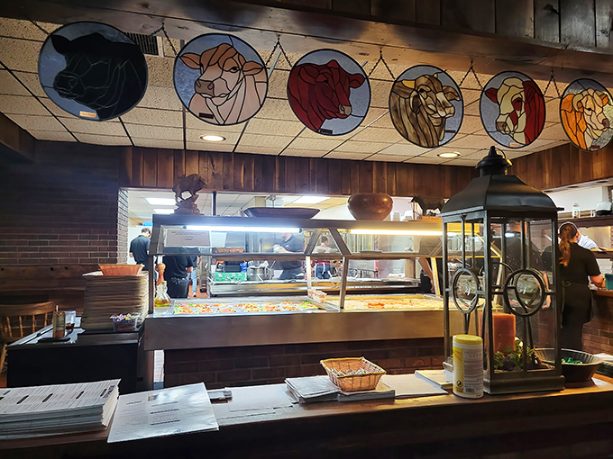 Stained glass cattle watch over the kitchen pass—a steak house that literally puts its mission statement on the ceiling.
