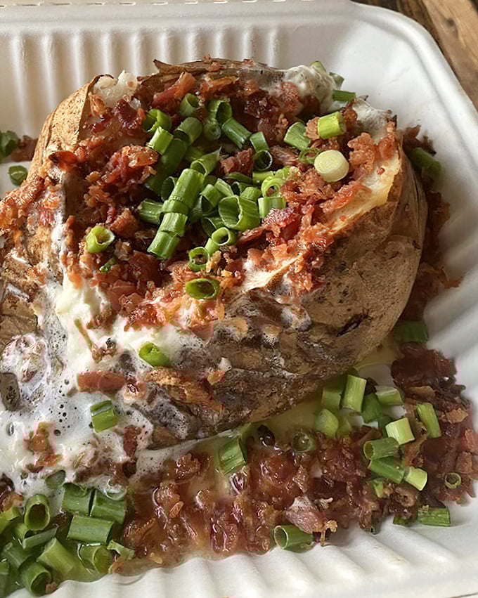 This loaded baked potato isn't messing around. Bacon, cheese, green onions—it's comfort food that doesn't apologize for being exactly what you want.