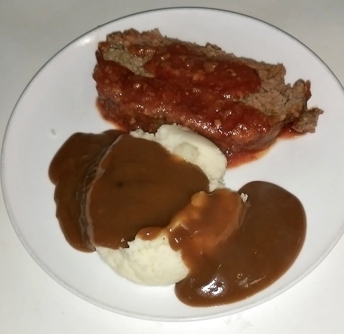 Meatloaf and mashed potatoes – the dynamic duo of Midwestern comfort food, swimming in gravy that deserves its own fan club.