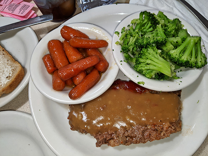 A meatloaf dinner that's worth the drive—homestyle gravy, bright carrots, and broccoli still with some bite, proving comfort food doesn't have to mean beige.