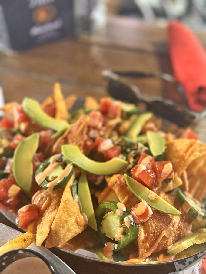 These aren't just nachos—they're an architectural marvel of crispy chips, fresh avocado, and enough toppings to require an engineering degree.