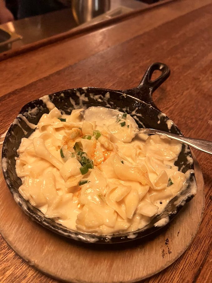 The Noodle Bake arrives bubbling with four cheeses in a cast iron skillet—comfort food that's had a serious upgrade without losing its soul.