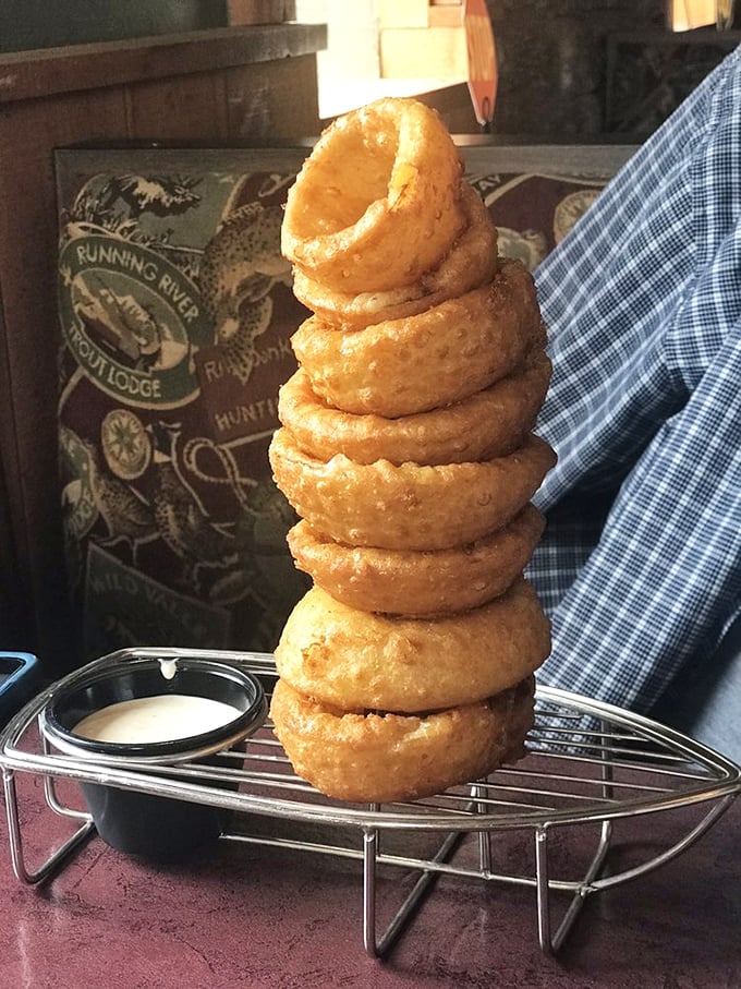 An onion ring tower that demands respect and strategy—do you start from the top or bottom? Either way, dipping sauce is mandatory.