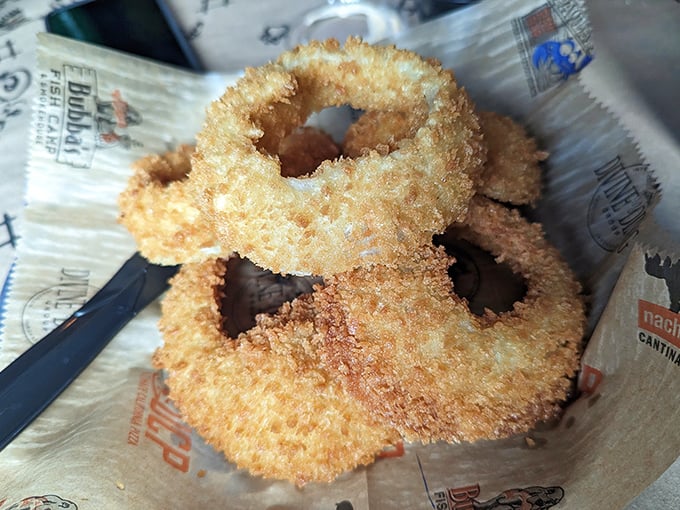 Golden-fried onion rings that shatter with each bite. These aren't just sides—they're crispy halos of happiness worth fighting over.