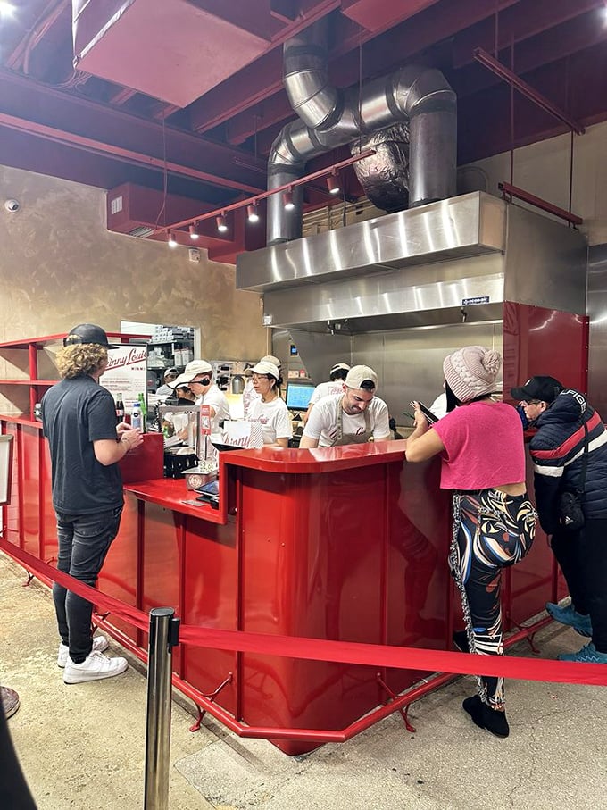 The red counter where burger dreams come true—a simple transaction that ends with you holding happiness between two buns.