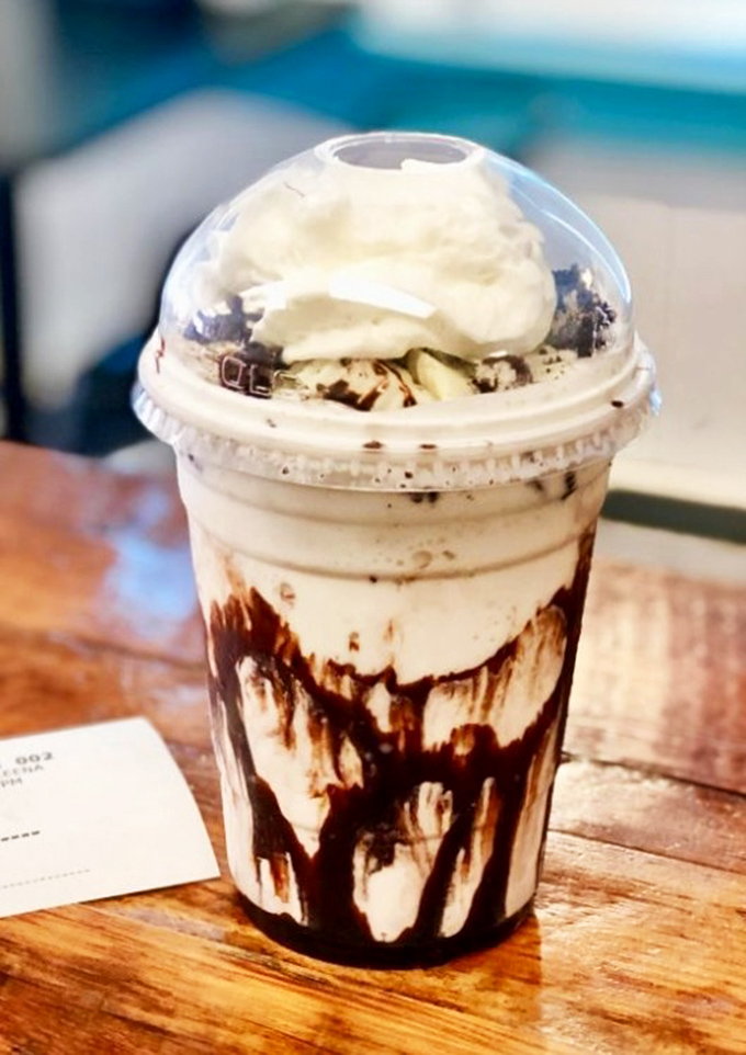 This isn't just a milkshake—it's dessert with drinking privileges. Chocolate swirls creating a work of drinkable art.