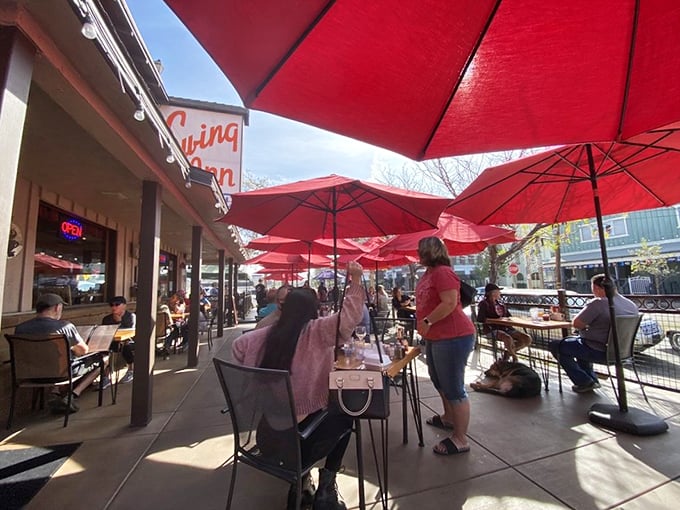 The outdoor patio where Temecula sunshine meets BBQ satisfaction under a canopy of cheerful red umbrellas.