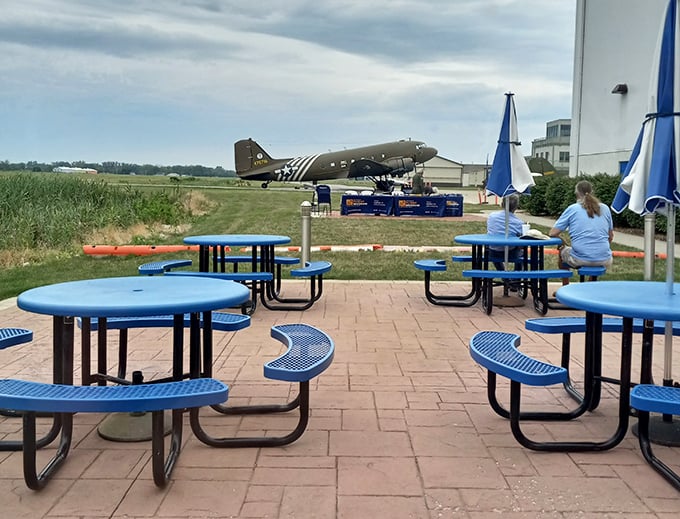 Outdoor dining with a vintage aircraft backdrop – because breakfast should always include adventure.