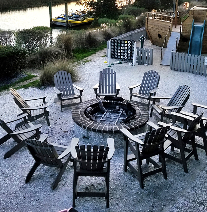 Adirondack chairs circling a fire pit by the marsh—where post-dinner conversations and sunset views create perfect Lowcountry evenings.