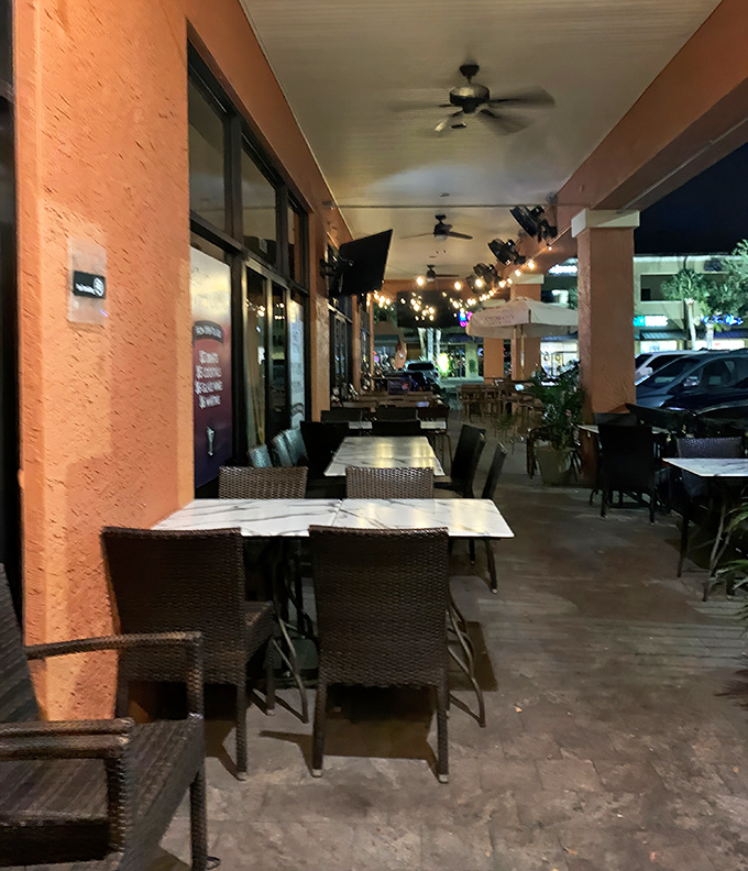 The outdoor seating area whispers, "Stay awhile and enjoy the Florida evening," while string lights add a touch of magic.